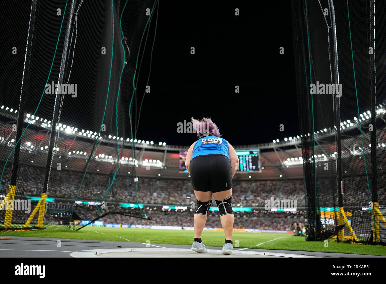 Hanna Skydan, of Azerbaijan, reacts watching her hammer hit the net in ...