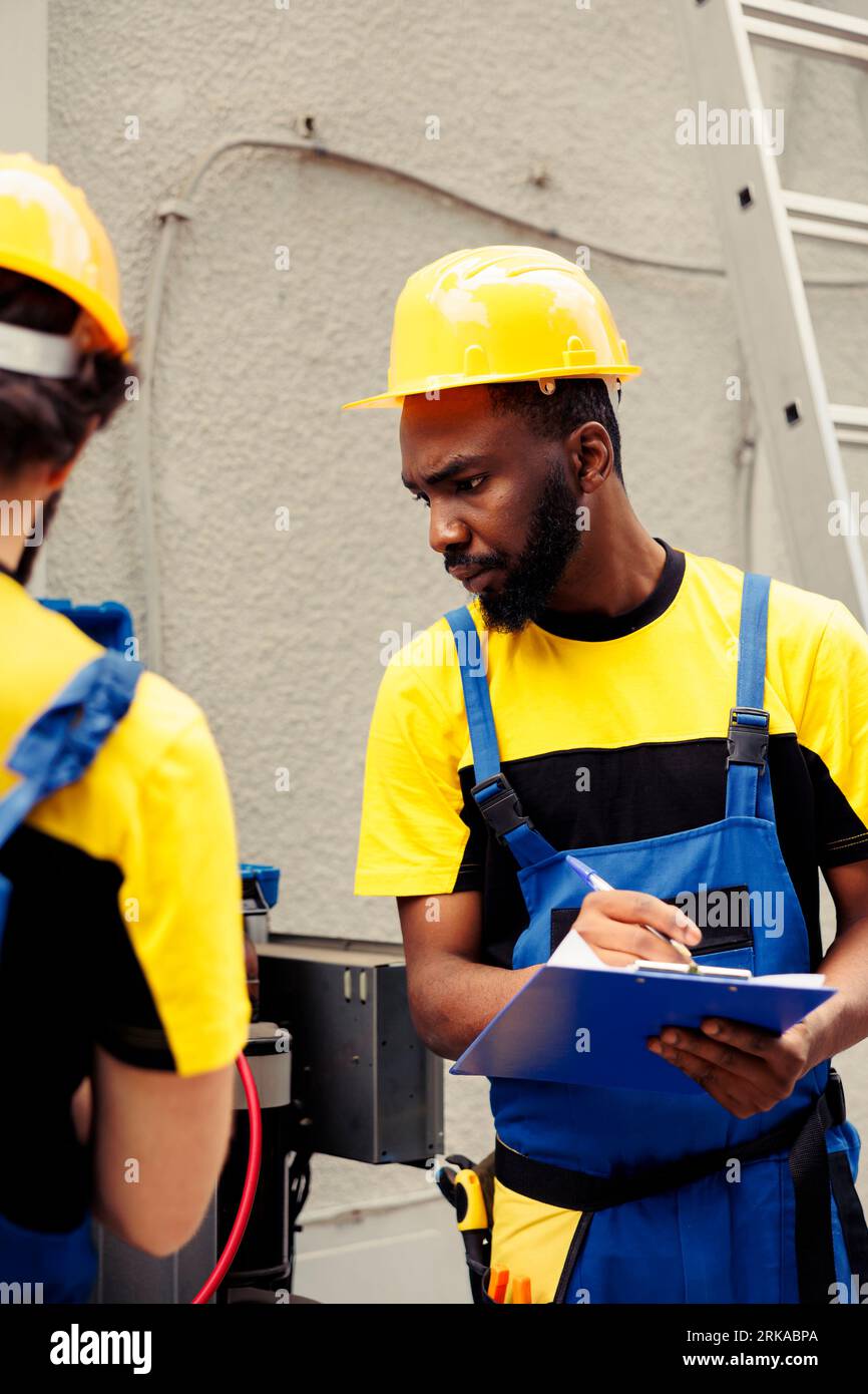 Licensed serviceman starting routine condenser maintenance, using ...