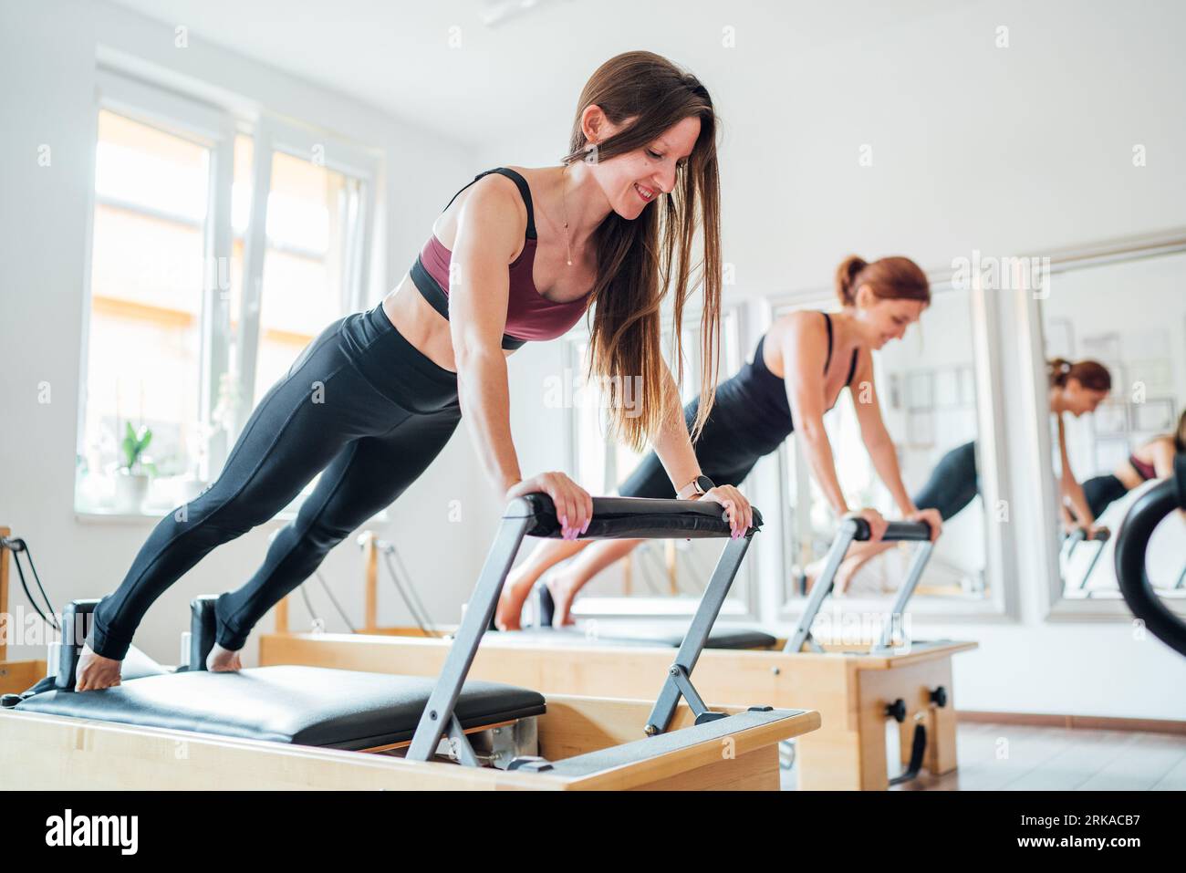 Two young females doing extended plank static strengthening core ...