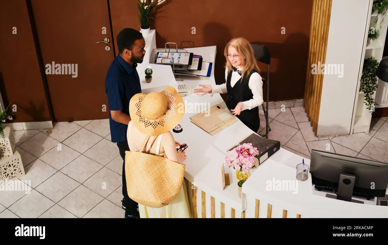 Diverse couple doing check in hi-res stock photography and images - Alamy