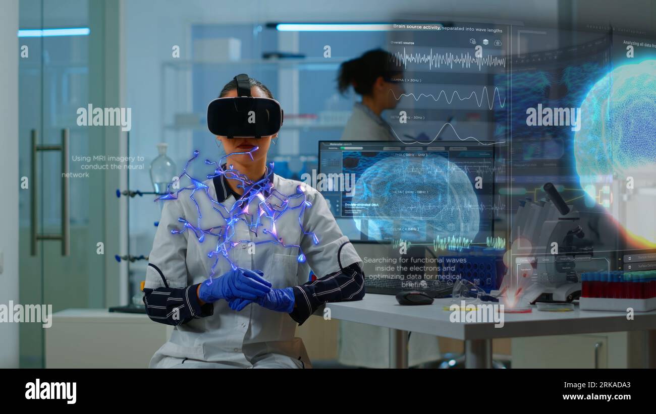 Scientific expert in laboratory wearing VR headset, using advanced equipment and wired sensors ...