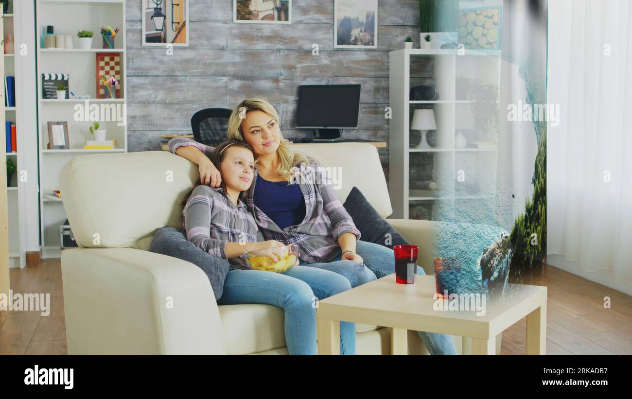 Happy family looking at nature documentary on AR projector display ...