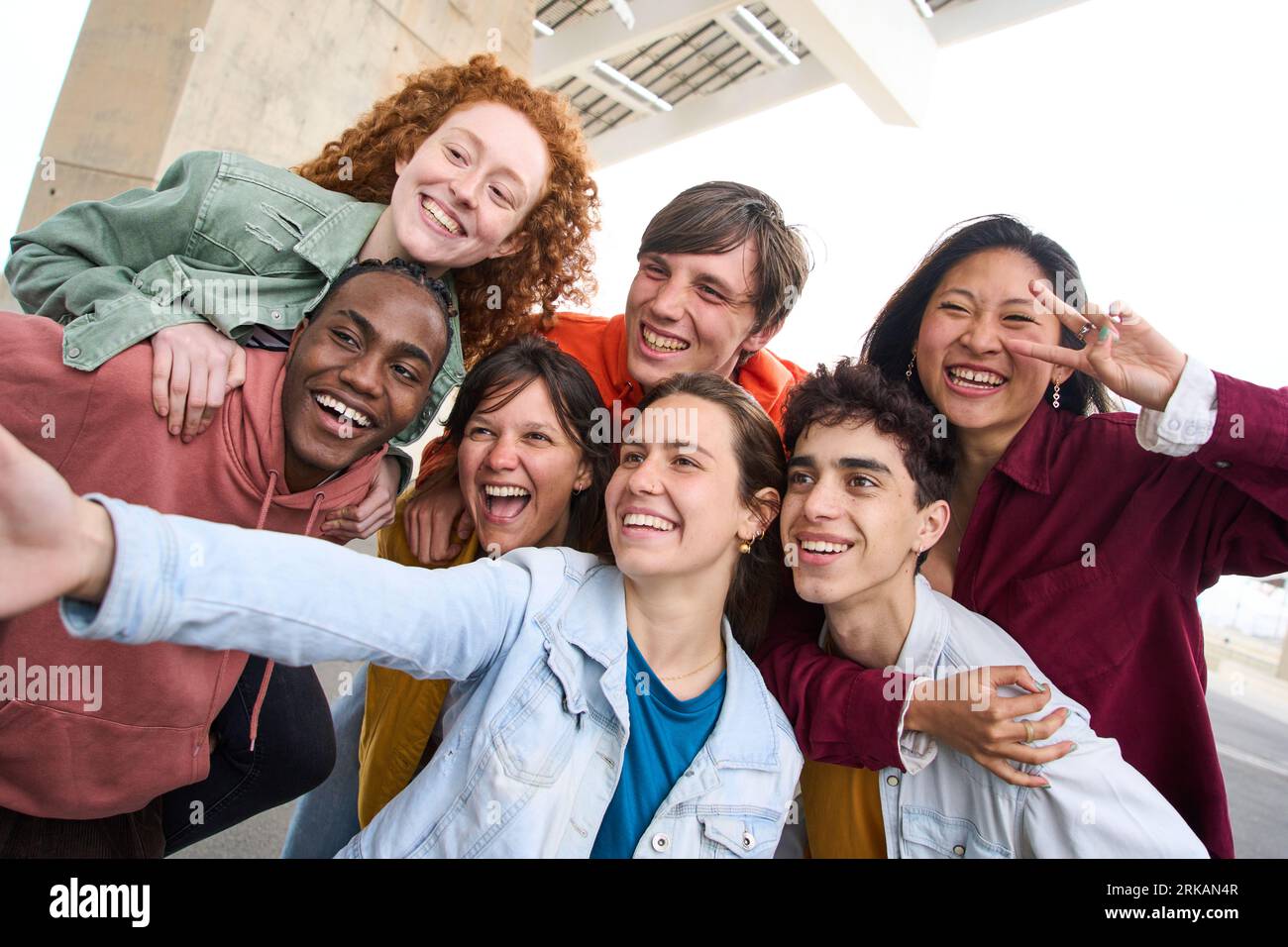 Mobile selfie of group of diverse young friends smiling outdoor. Happy people posing together ...