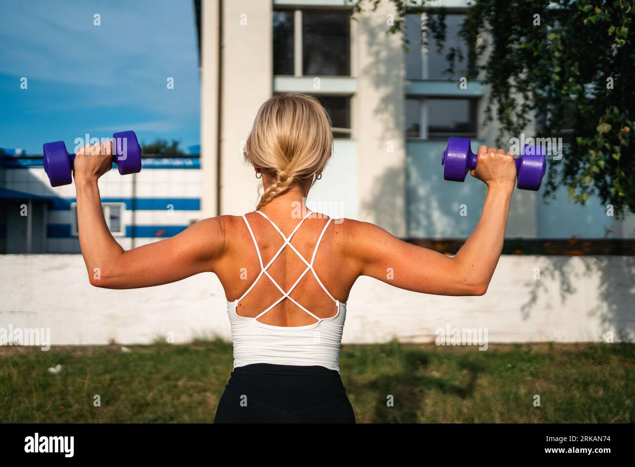 Beautiful blonde middle age woman doing weights exercises with ...