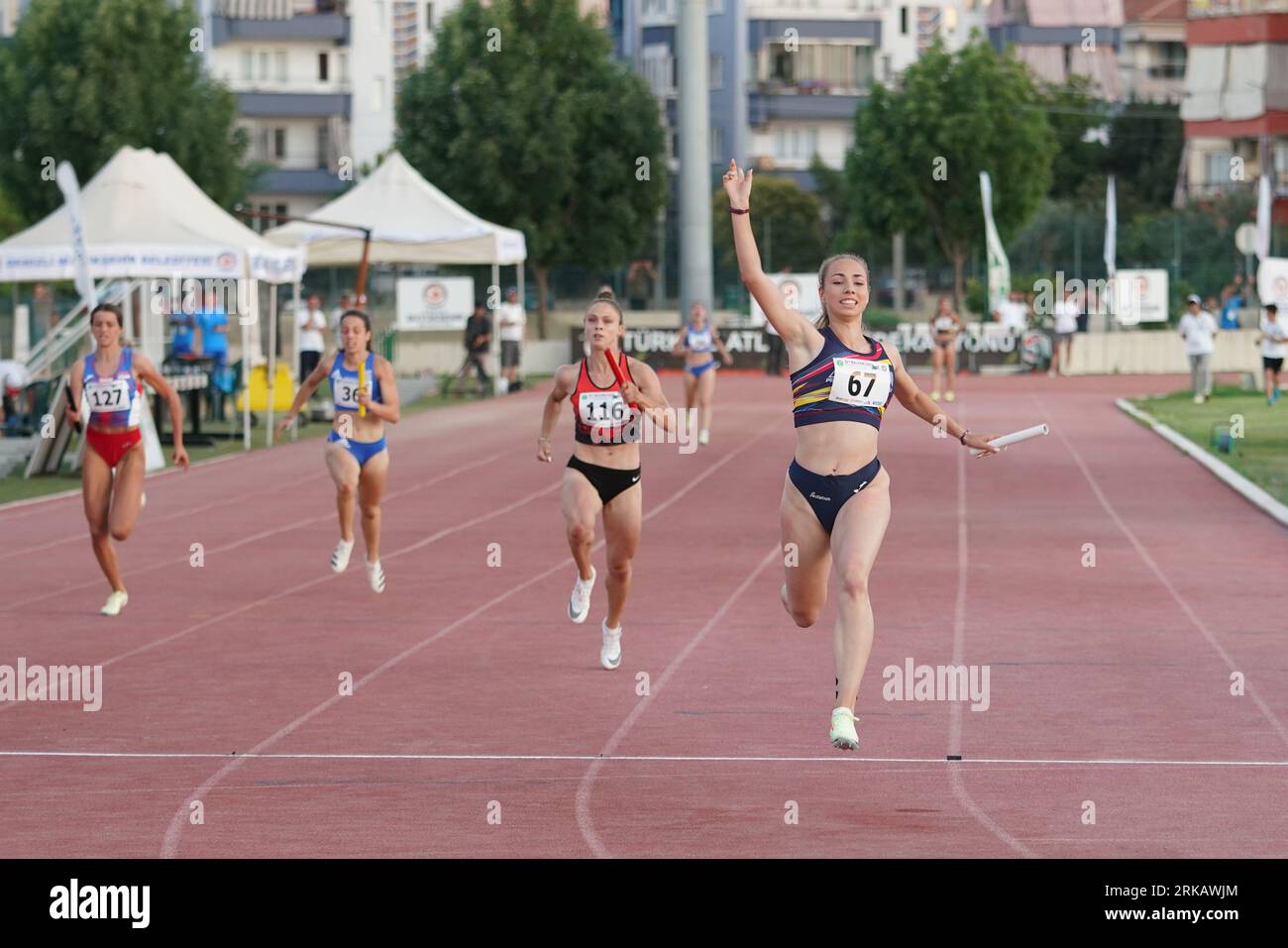DENIZLI, TURKIYE - JULY 16, 2022: Athletes running 4x100 metres relay ...