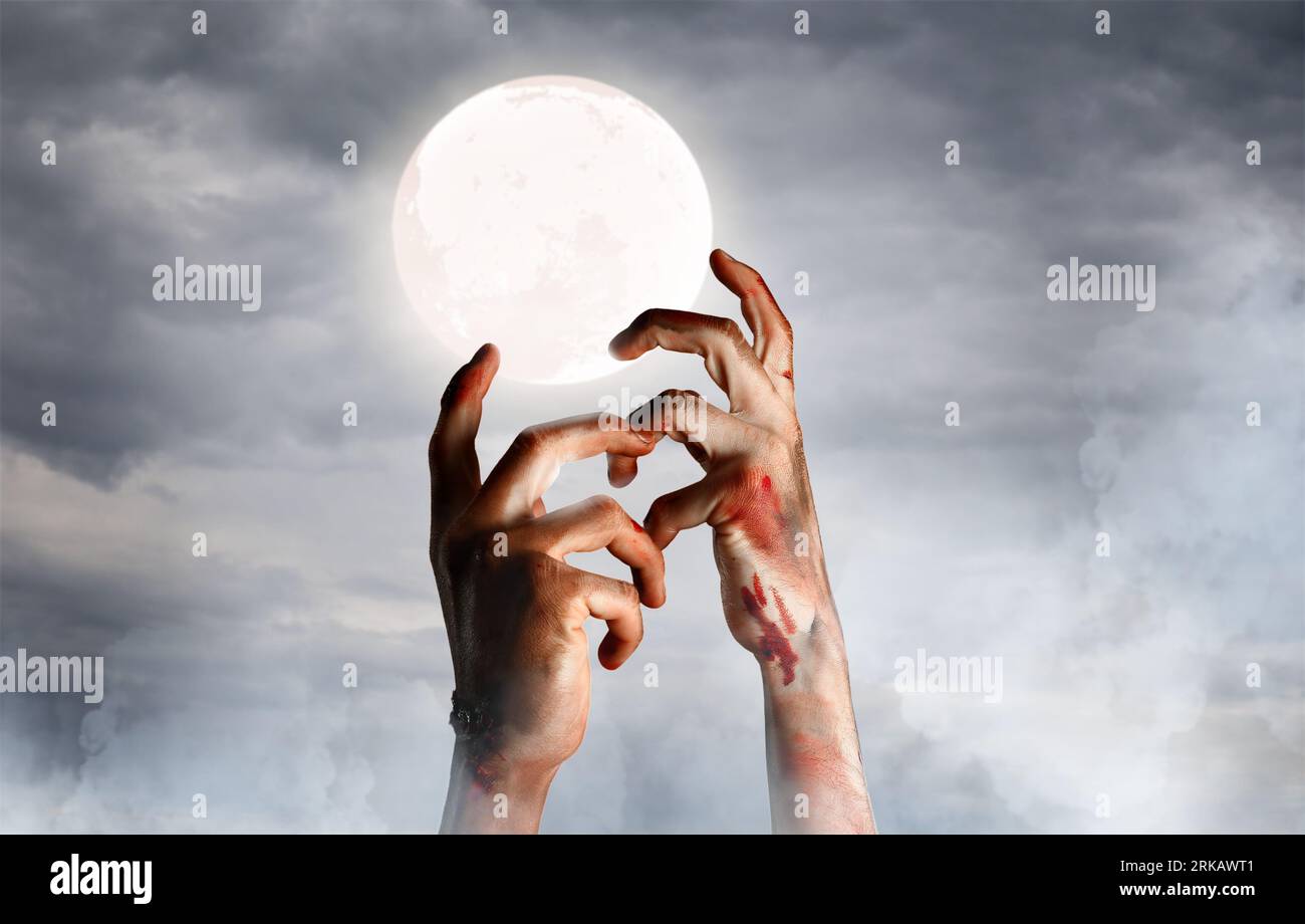 Hands of zombies and full moon in night sky Stock Photo - Alamy