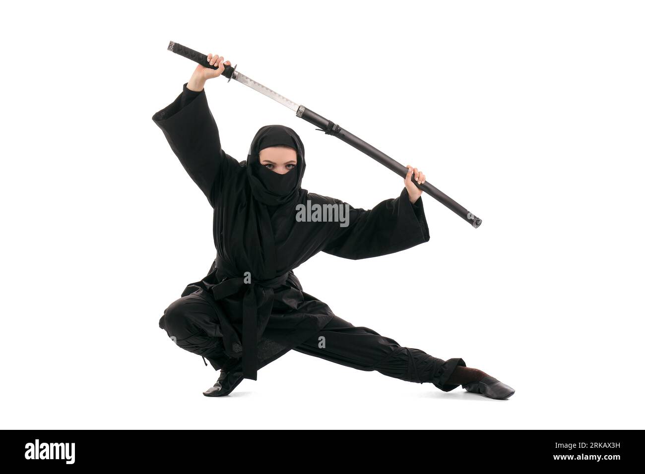 Female ninja with sword on white background Stock Photo - Alamy