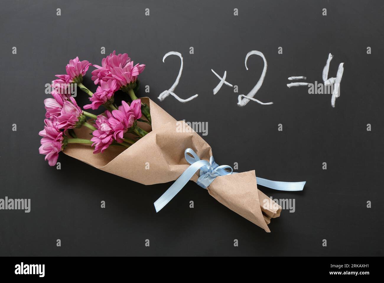 Beautiful flowers bouquet and maths formula on black chalkboard ...