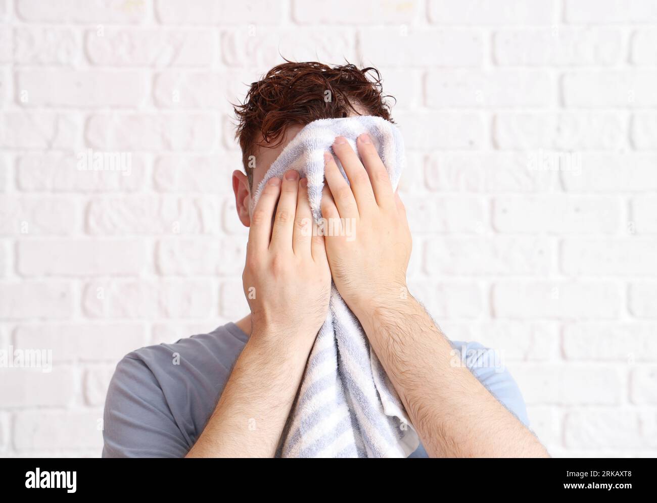 Man wiping face bath towel hi-res stock photography and images - Alamy