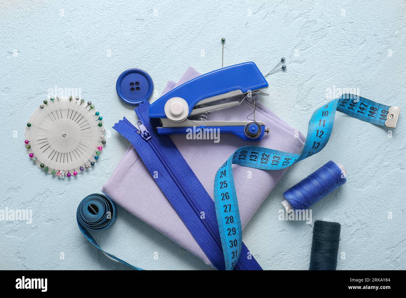 Manual sewing machine with different supplies on gradient background ...