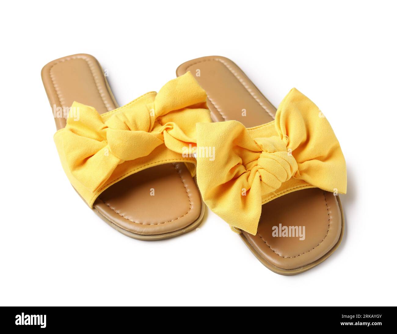 Yellow female flip flops on white background Stock Photo - Alamy