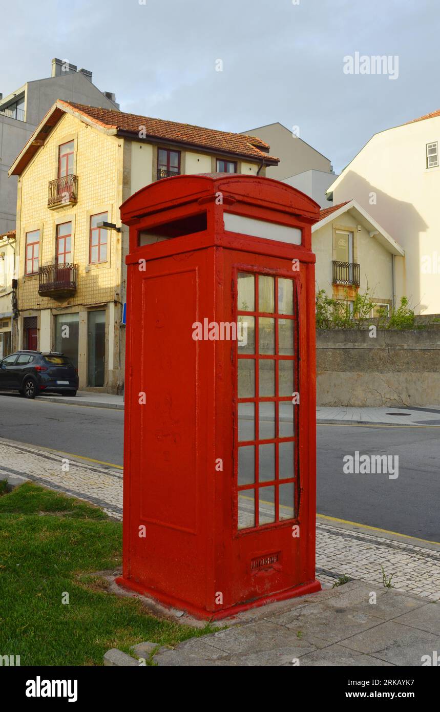 An English red telephone booth stands in a street in Porto Stock Photo ...