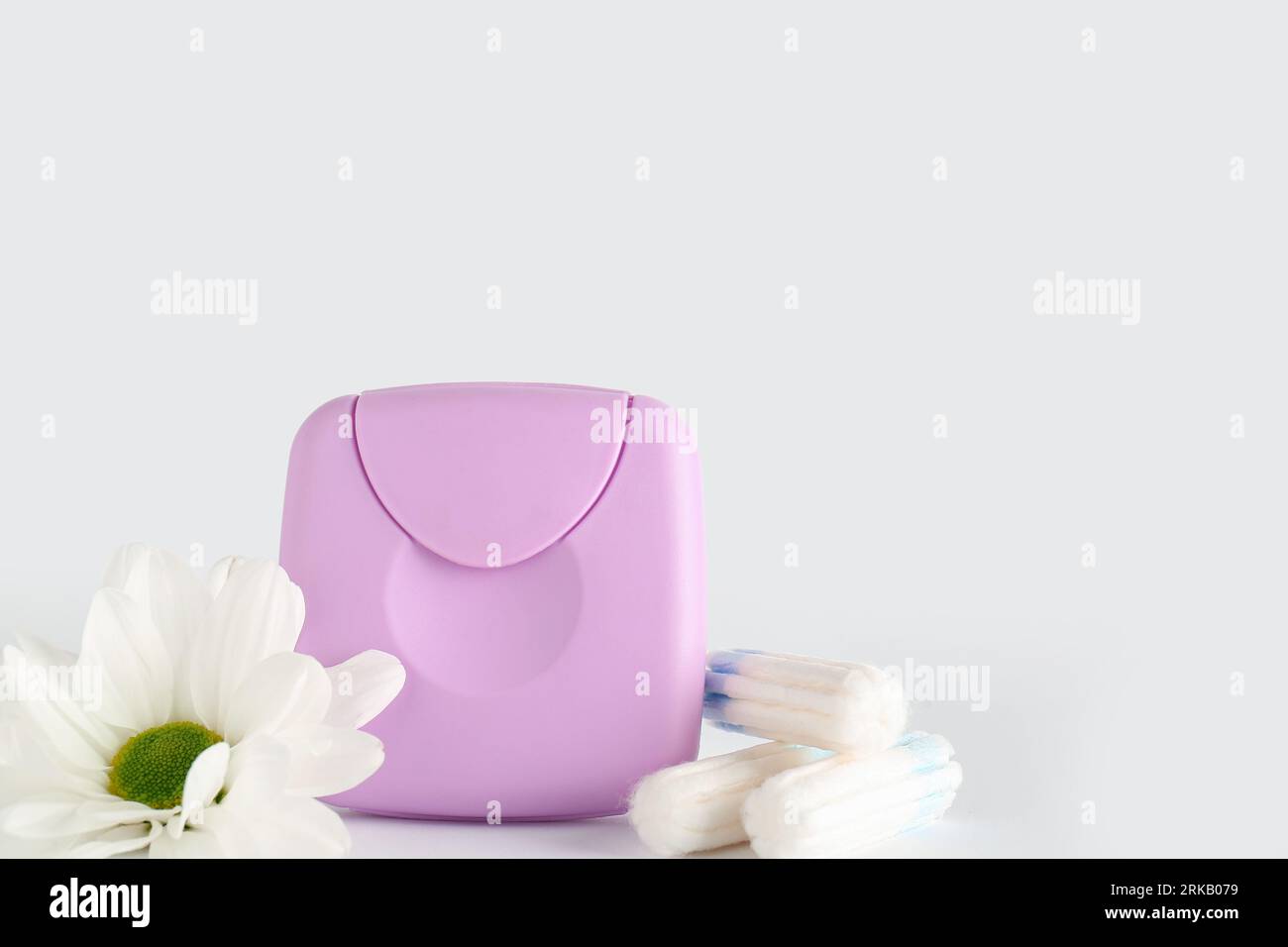 Menstrual tampons, storage box and chamomile flower on white background ...