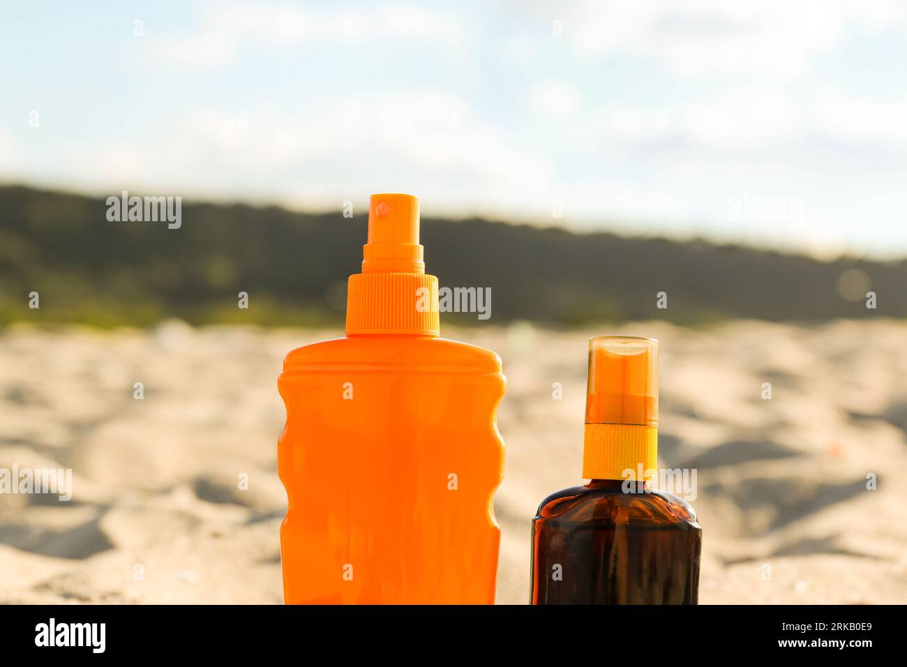Bottles of sunscreen cream on sand at beach Stock Photo - Alamy