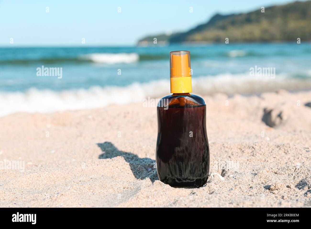 Bottle of sunscreen cream on sand near ocean at beach Stock Photo - Alamy