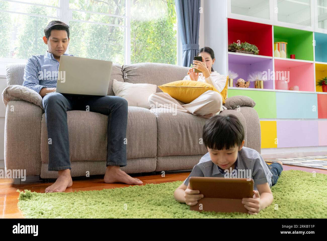 Family using different technology hi-res stock photography and images ...