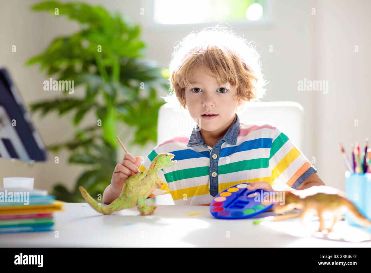 Online remote learning. School kids with computer having video ...