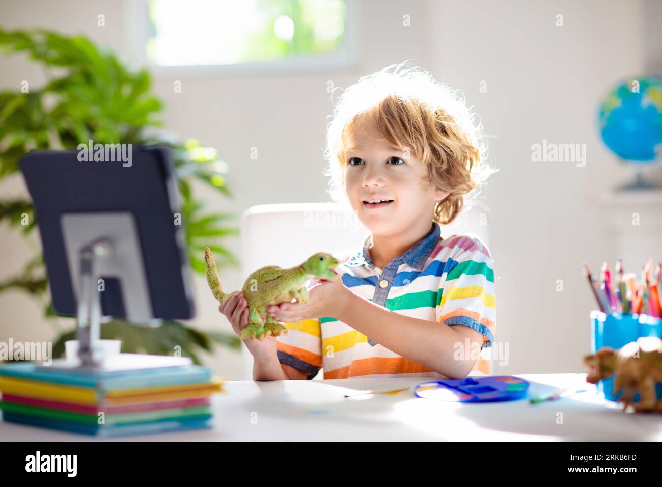 Online remote learning. School kids with computer having video ...