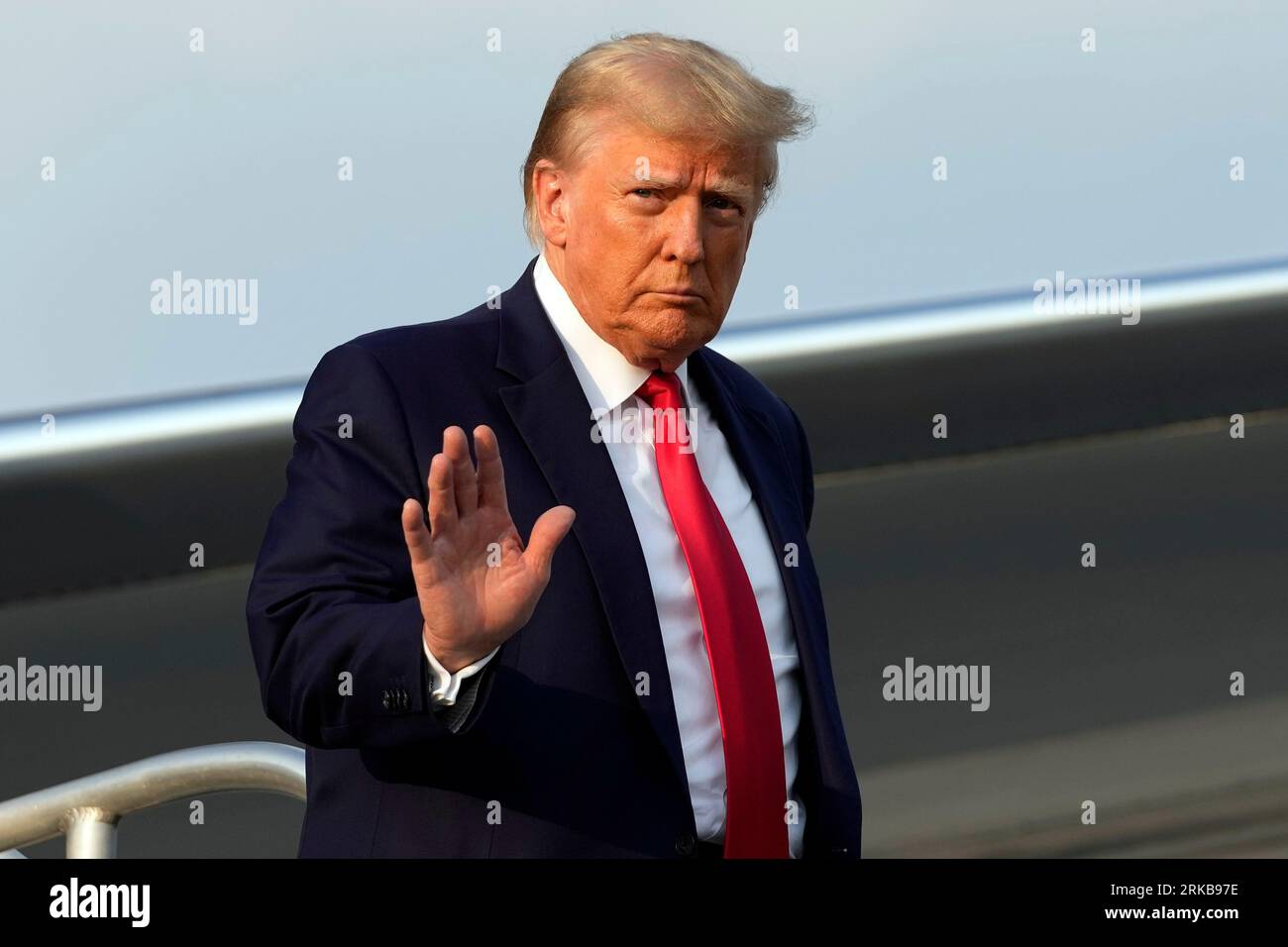Former President Donald Trump steps off his plane as he arrives at ...