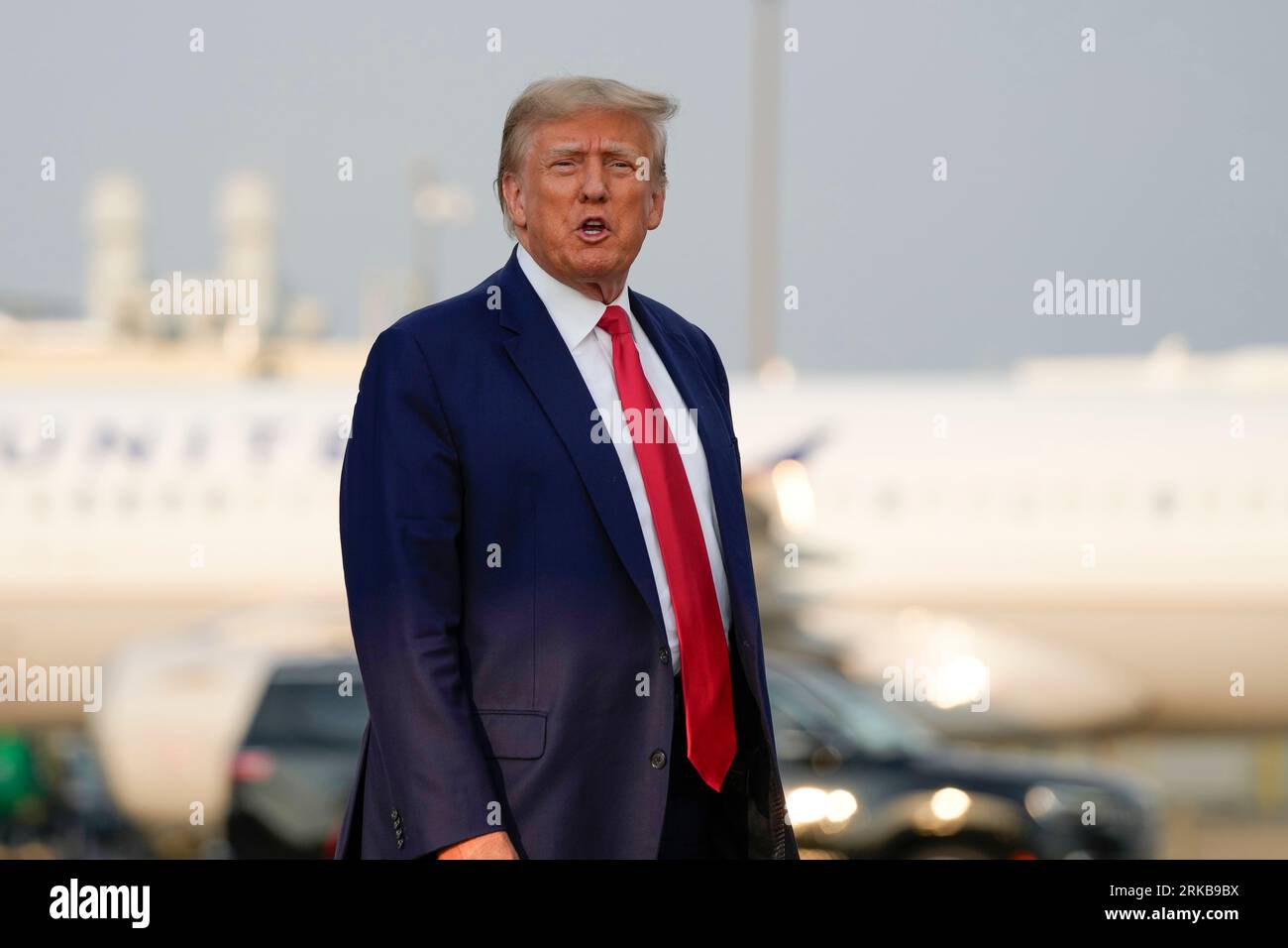 Former President Donald Trump steps off his plane as he arrives at ...