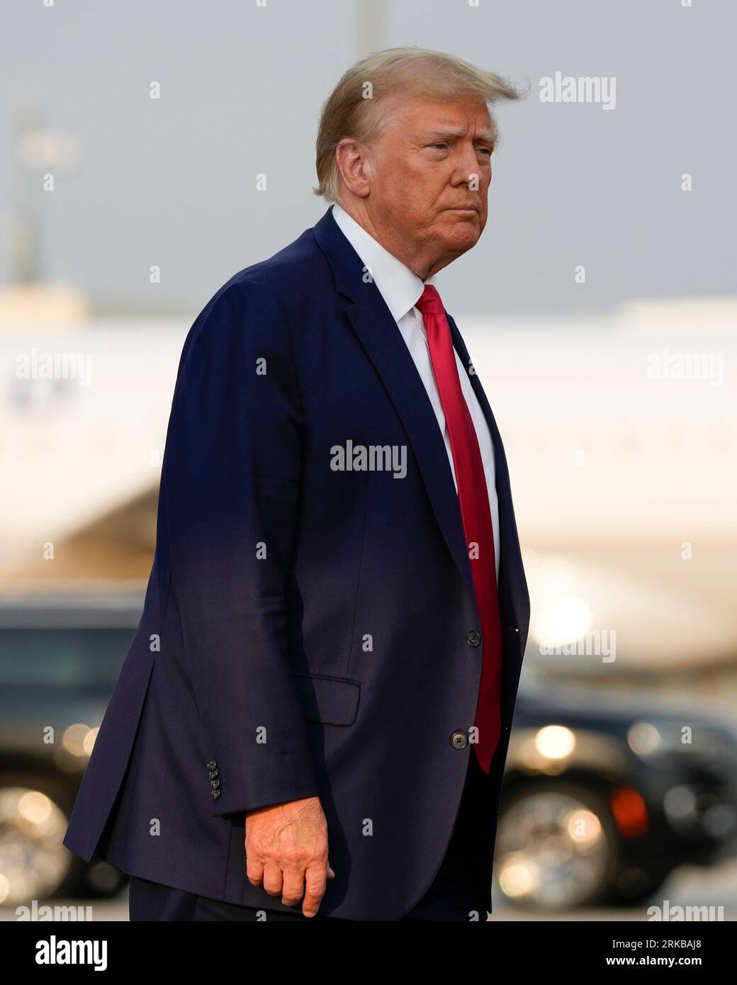 Former President Donald Trump steps off his plane as he arrives at ...