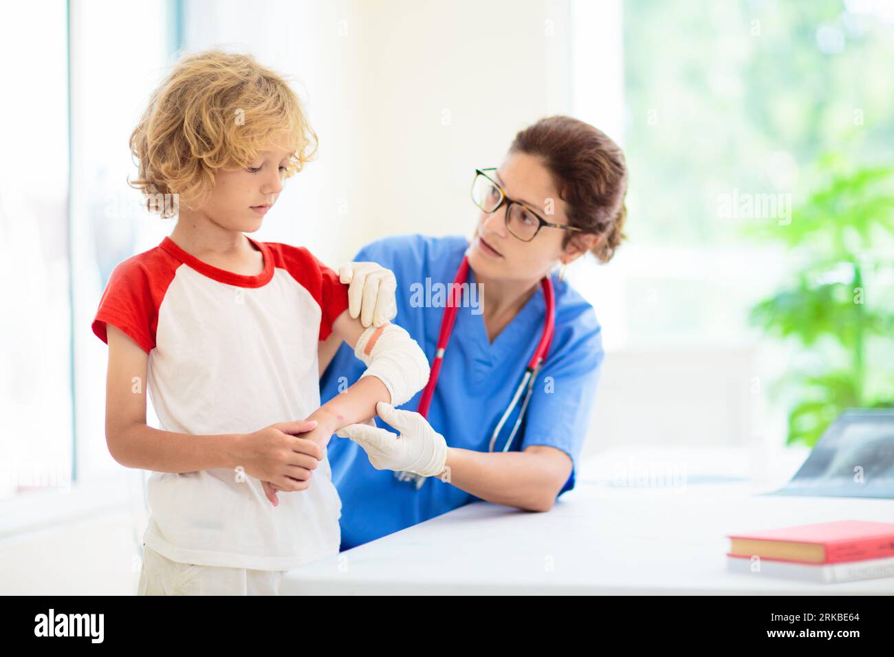 Child with arm injury at trauma and emergency care. Kid with elbow cast ...