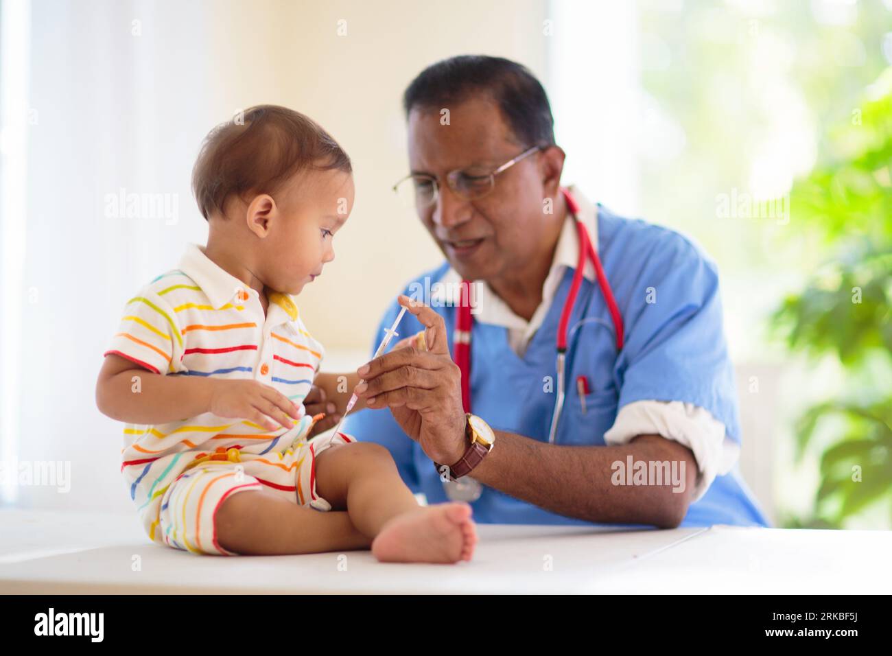 Pediatrician doctor examining baby. Asian boy in health clinic for test ...