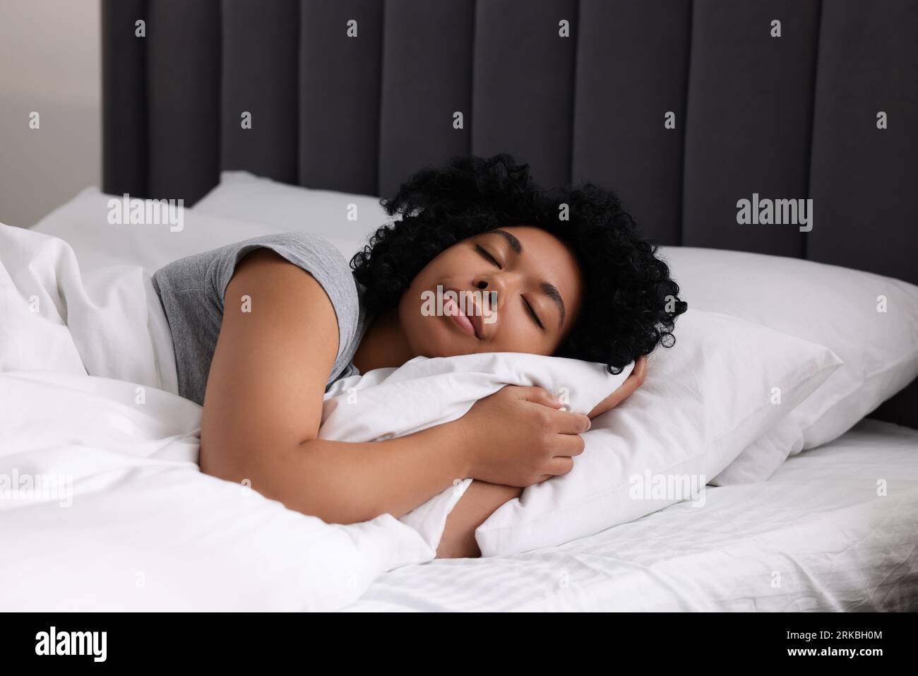 Beautiful young woman sleeping in soft bed Stock Photo - Alamy