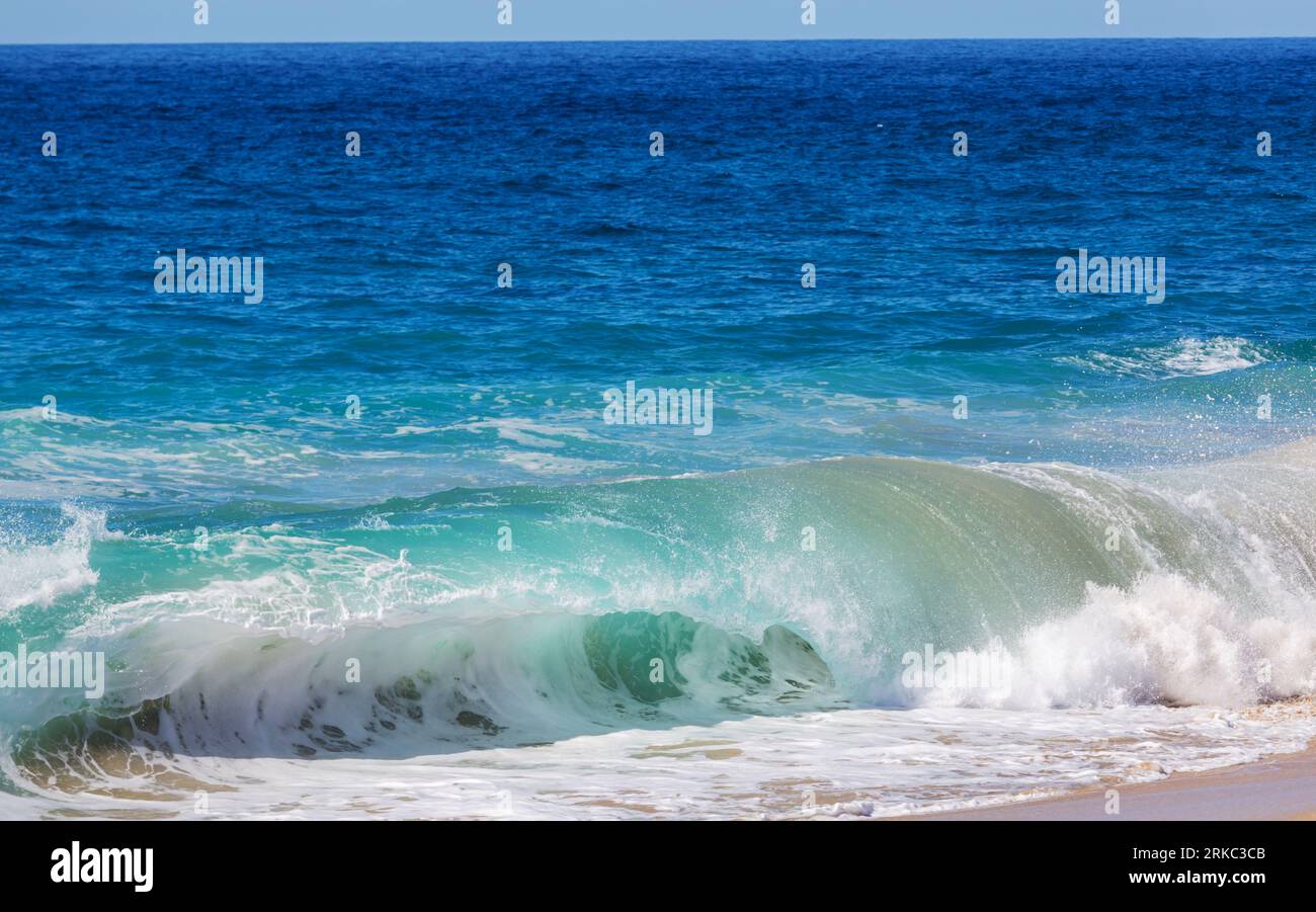Blue wave on the beach. Dramatic natural background Stock Photo - Alamy