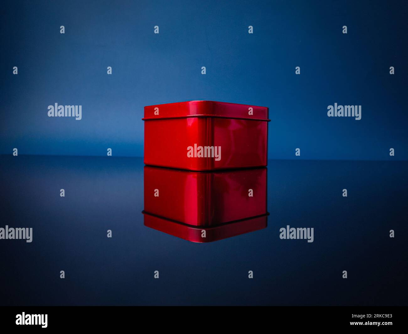 Steel red box with reflection on a black acrylic board Stock Photo - Alamy