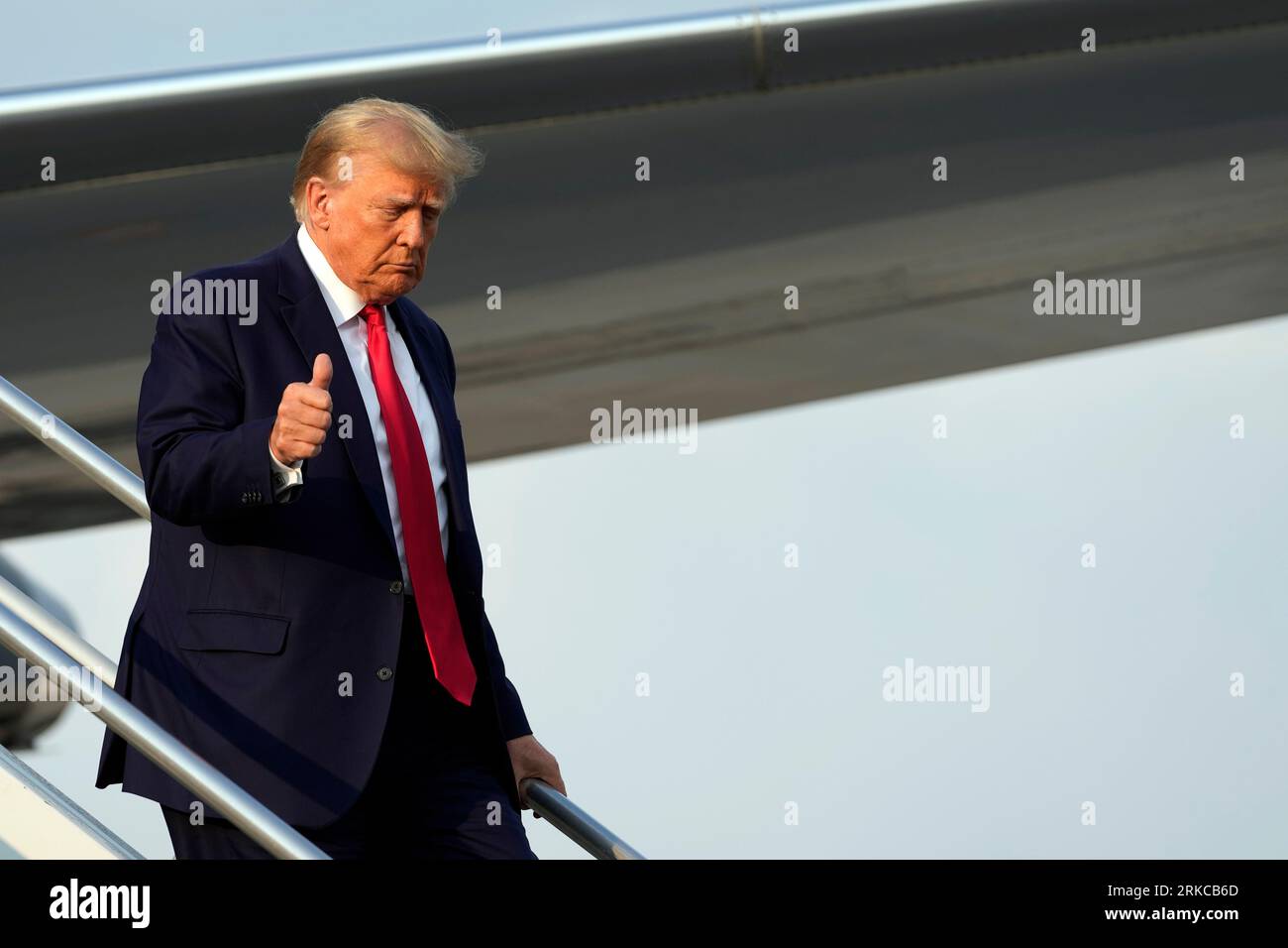 Former President Donald Trump steps off his plane as he arrives at ...