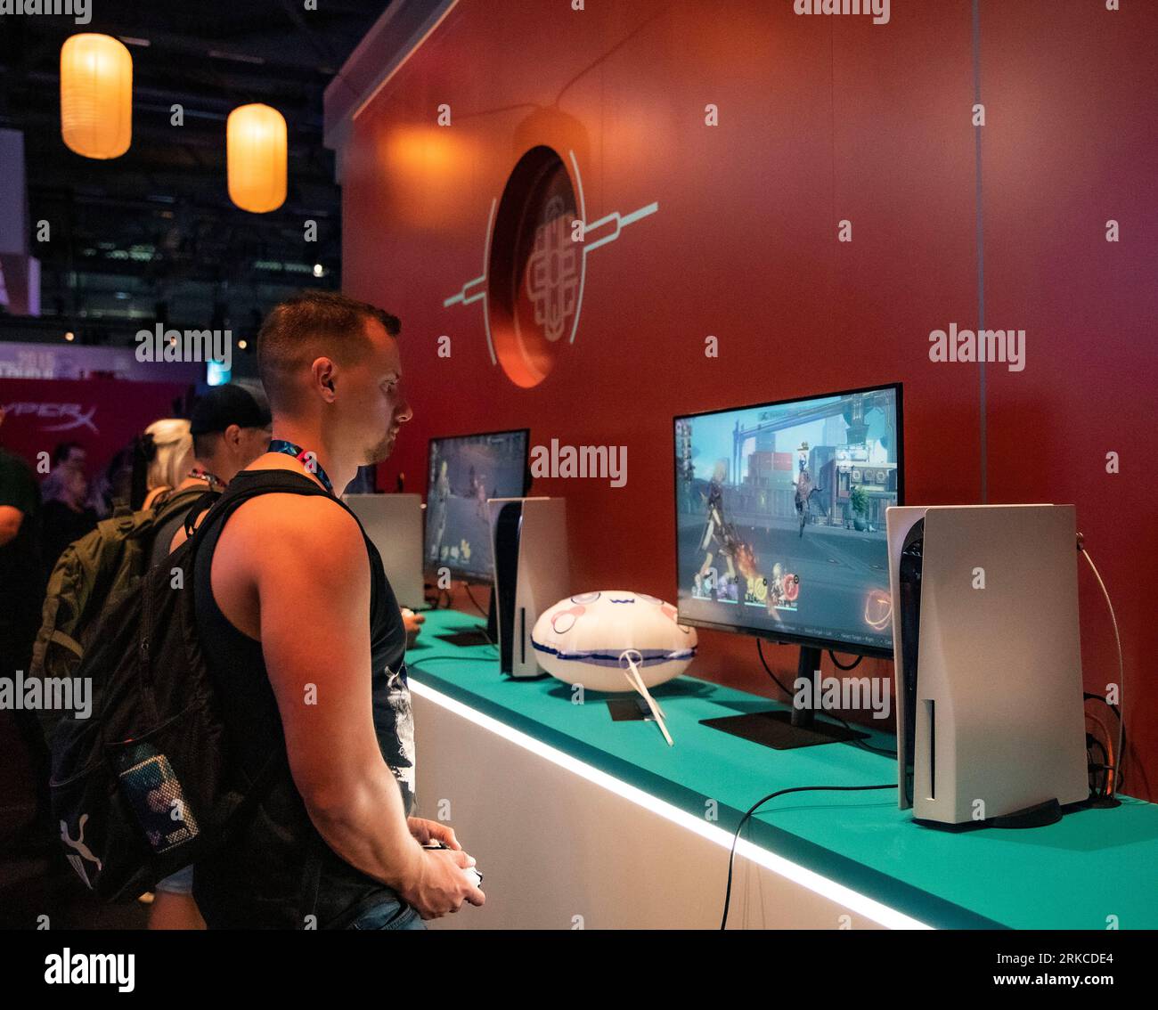 Cologne, Germany. 23rd Aug, 2023. People try games at the booth of ...