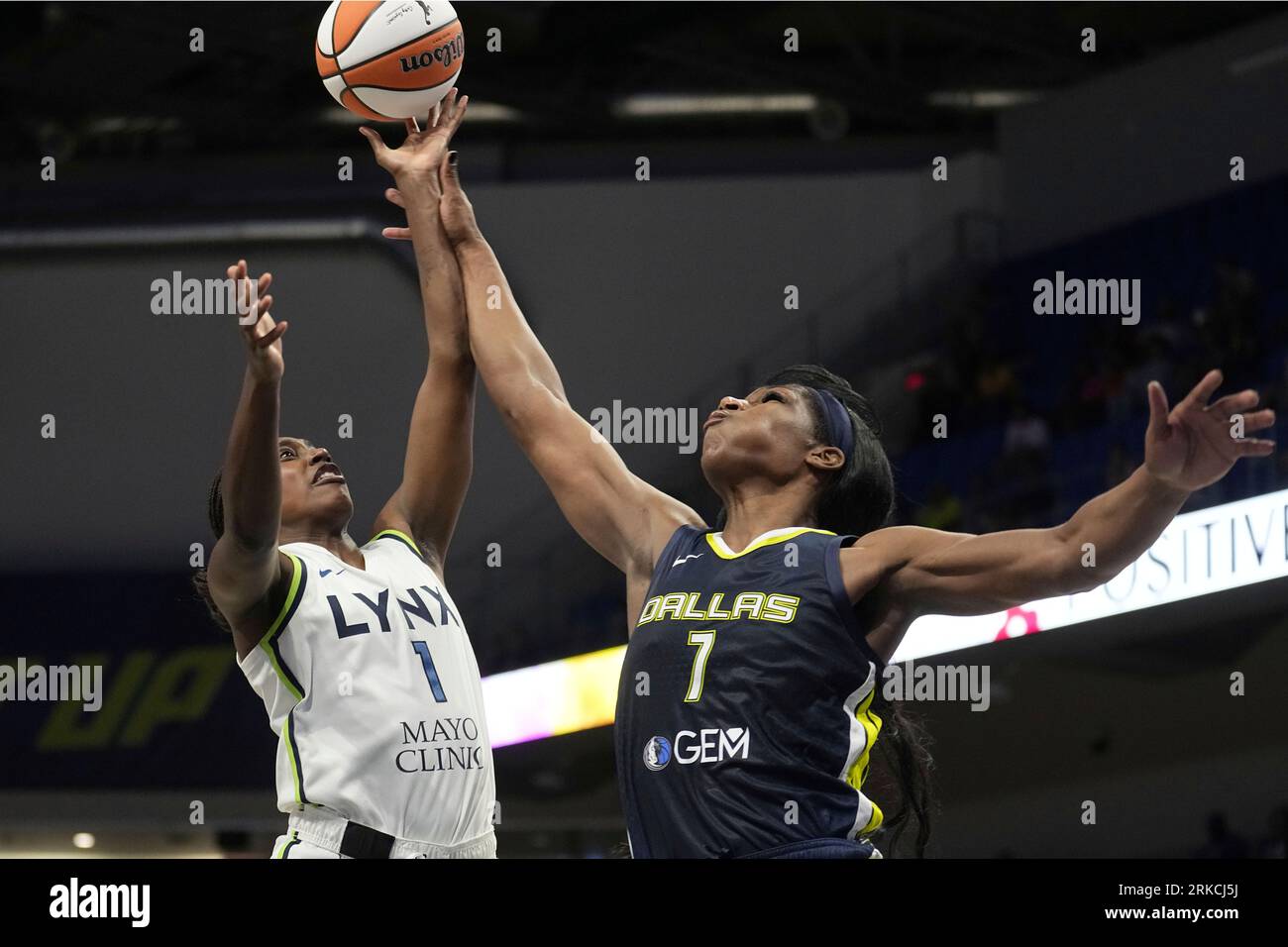 Minnesota Lynx guard Diamond Miller, left, is fouled by Dallas Wings ...