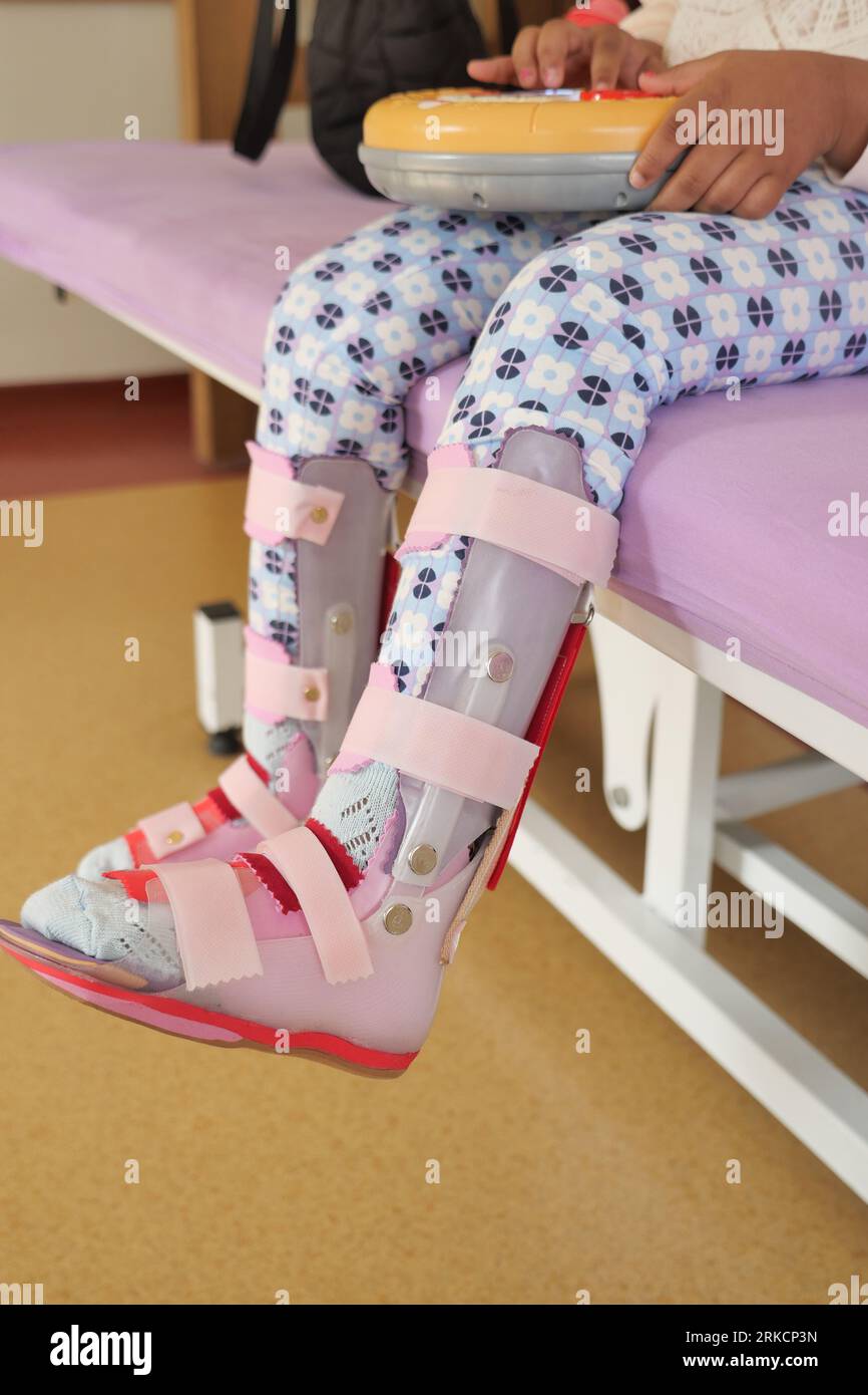 Child cerebral palsy disability, legs orthosis Stock Photo - Alamy