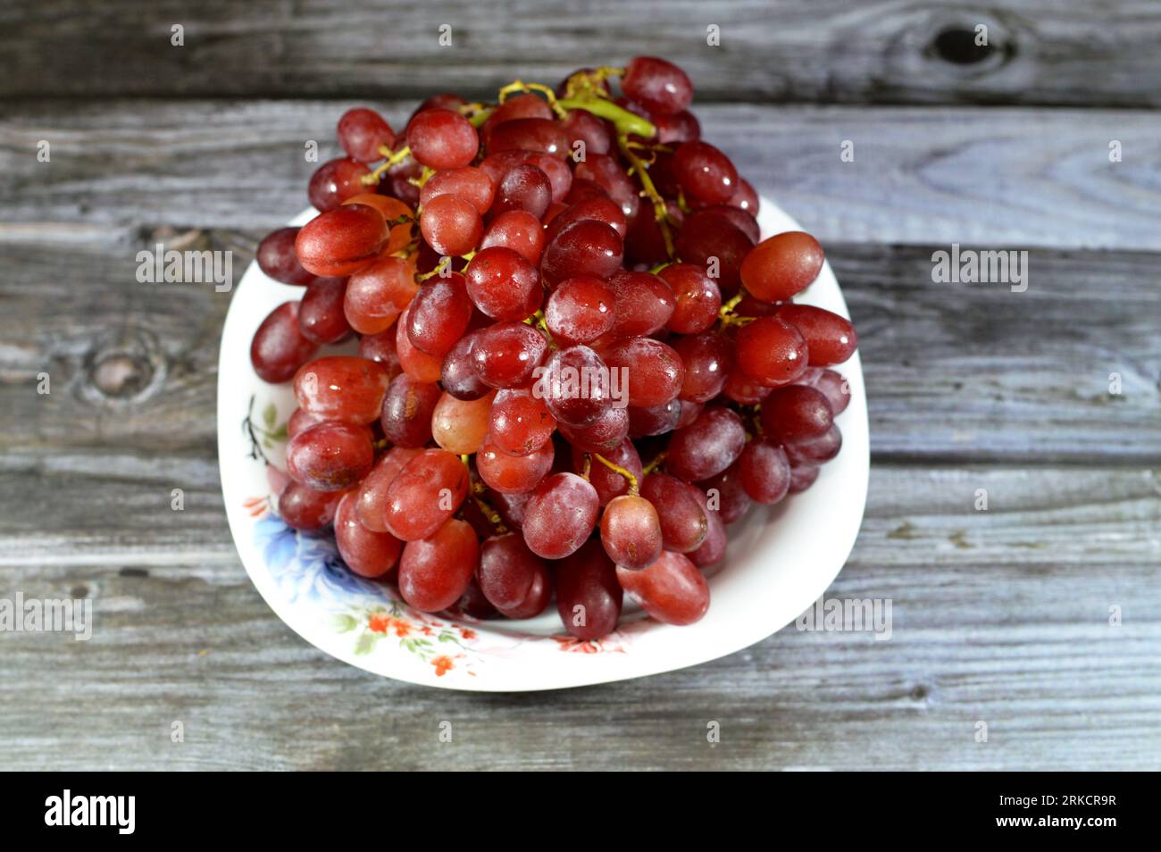 Red grapes, a fruit, botanically a berry of the deciduous woody vines ...