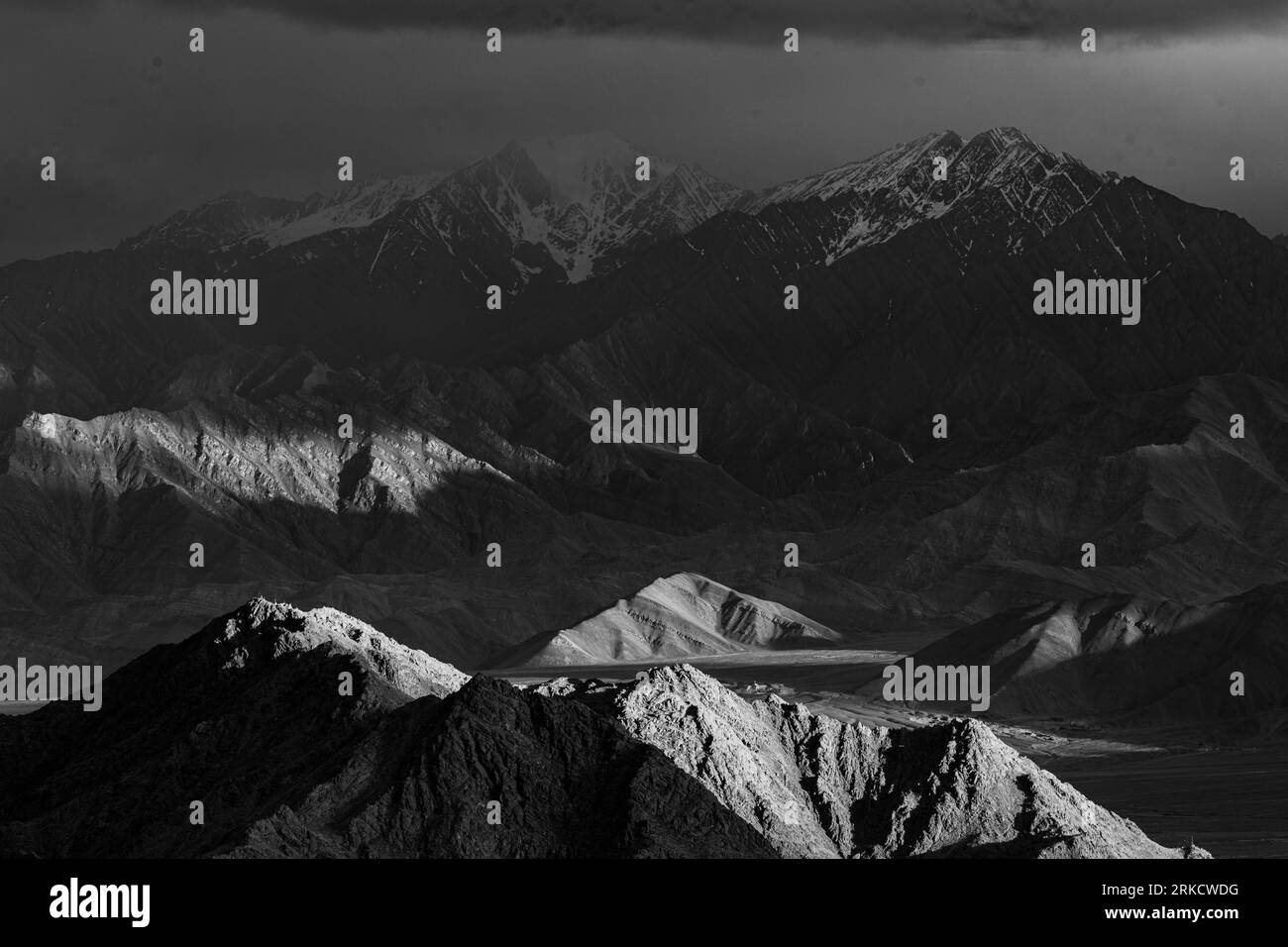 A panoramic landscape of light and shadows falling on mountains as fine ...