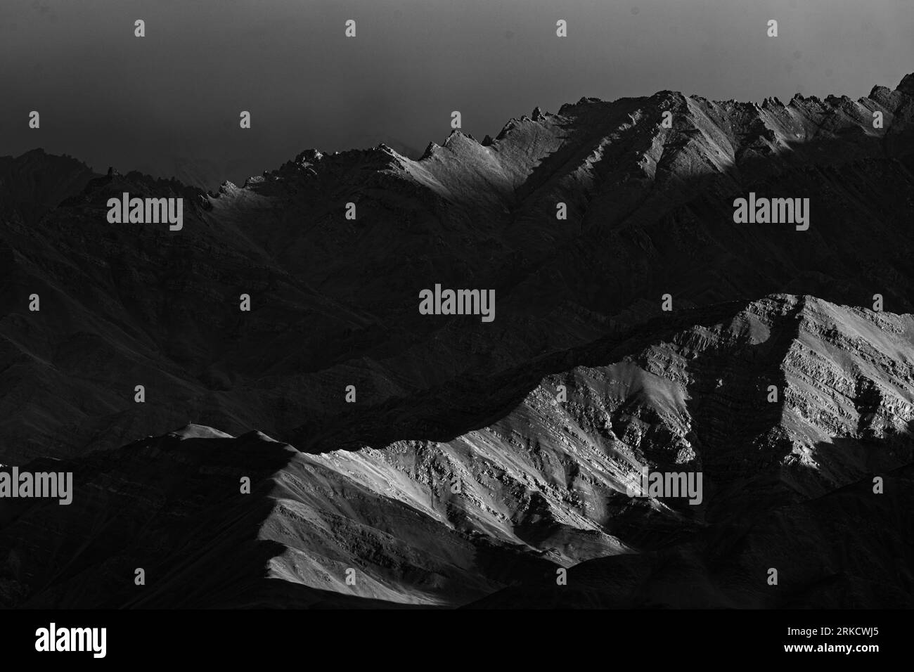 A panoramic landscape of light and shadows falling on mountains as fine ...