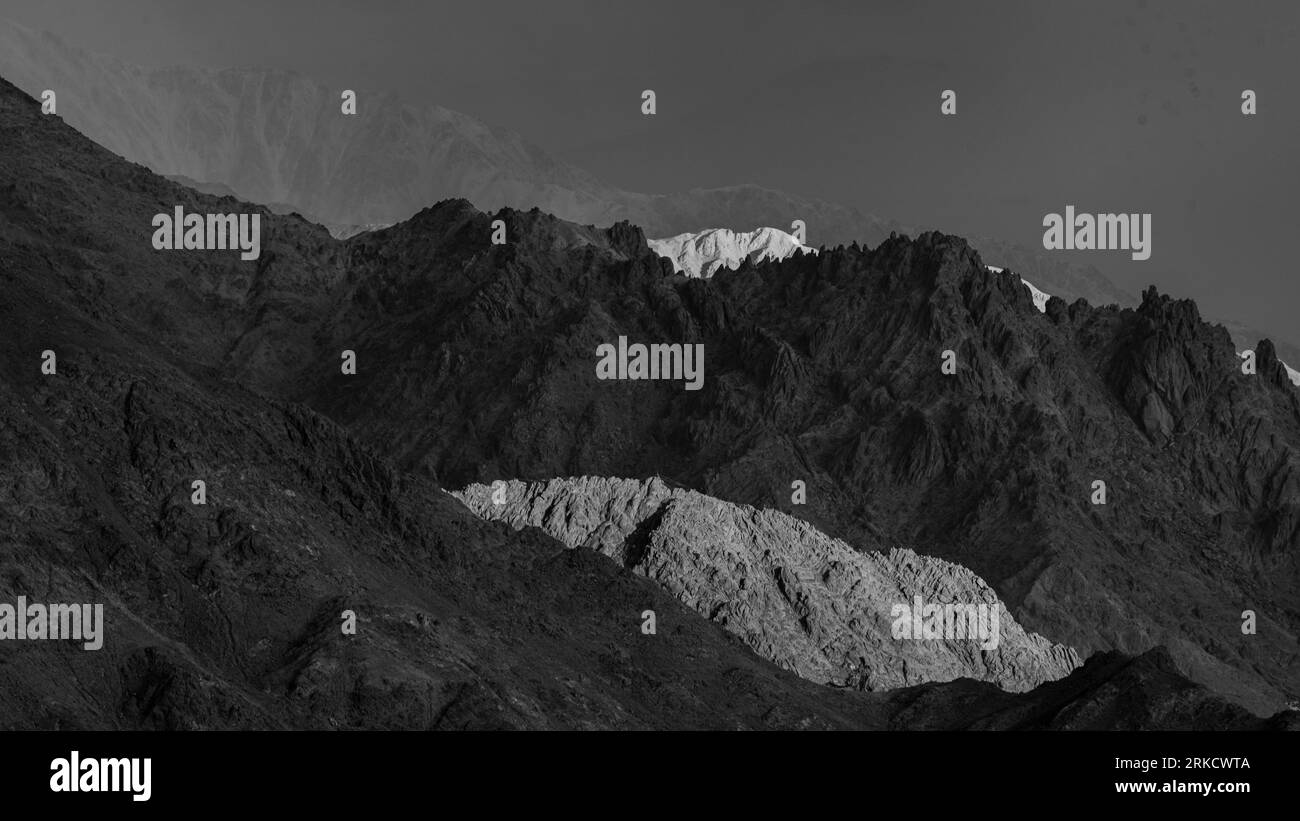 A panoramic landscape of light and shadows falling on mountains as fine ...