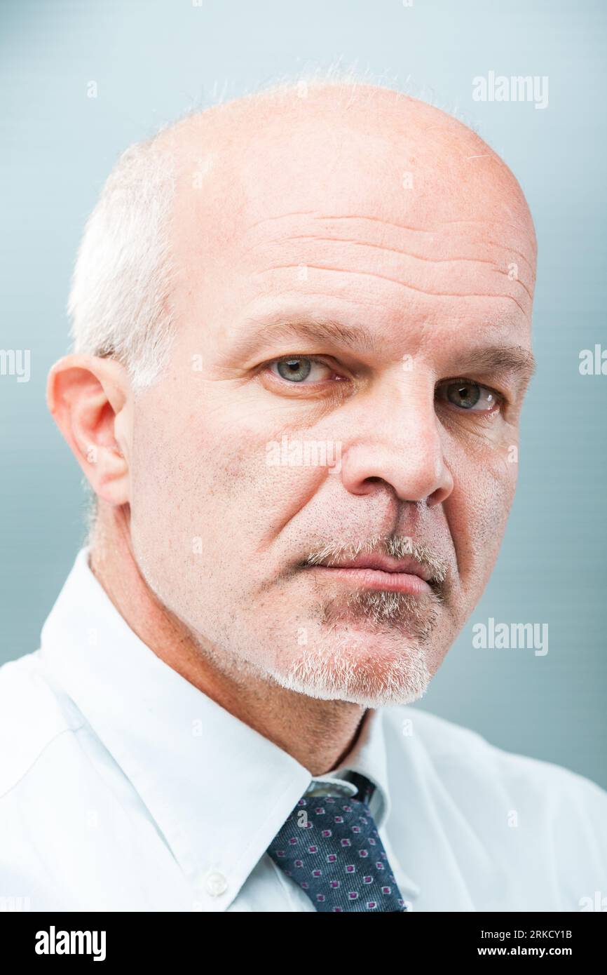 Detailed portrait of a resolute man, balding with white temple hair ...