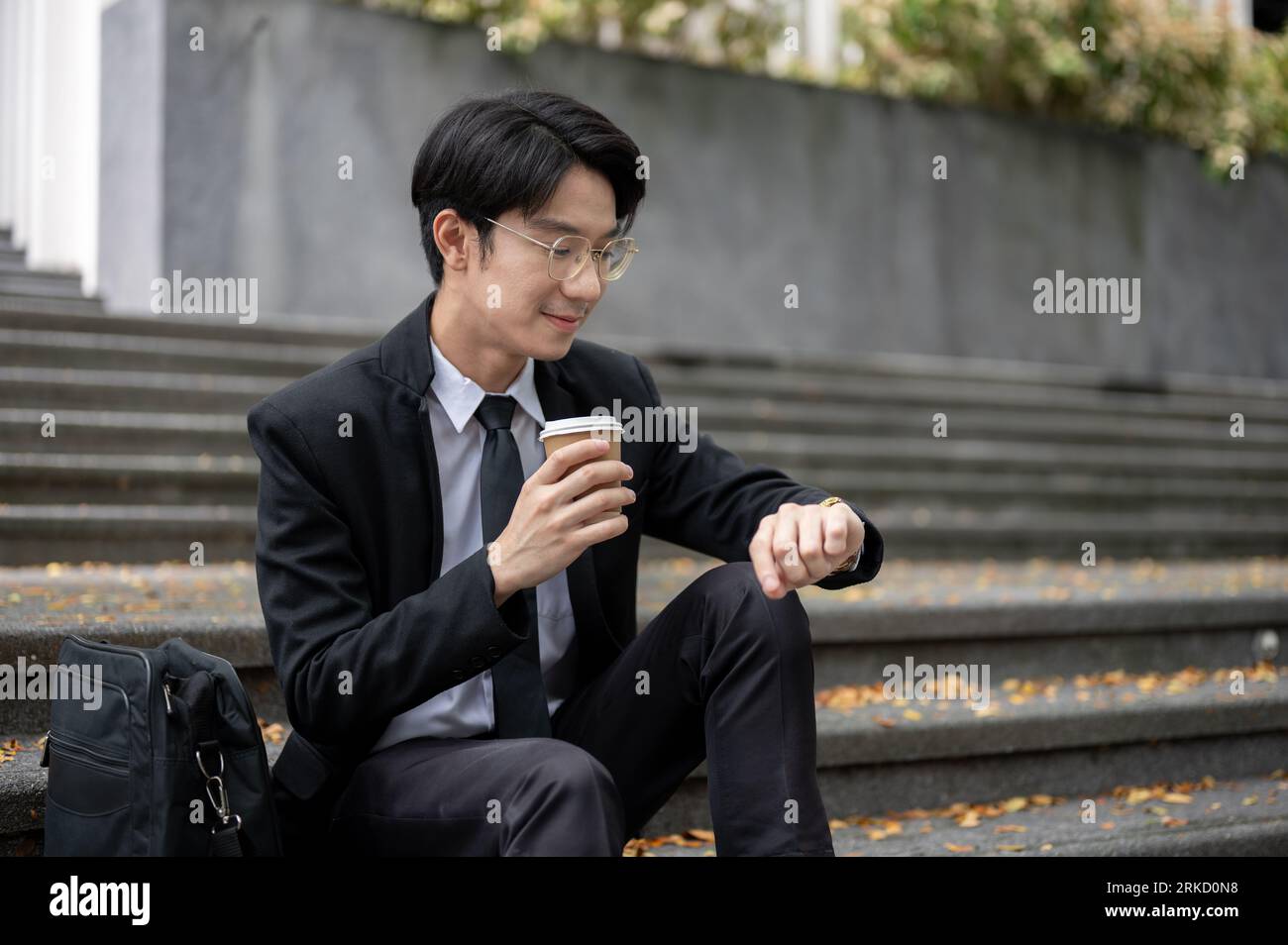 A handsome Asian businessman or male banker in a formal business suit ...