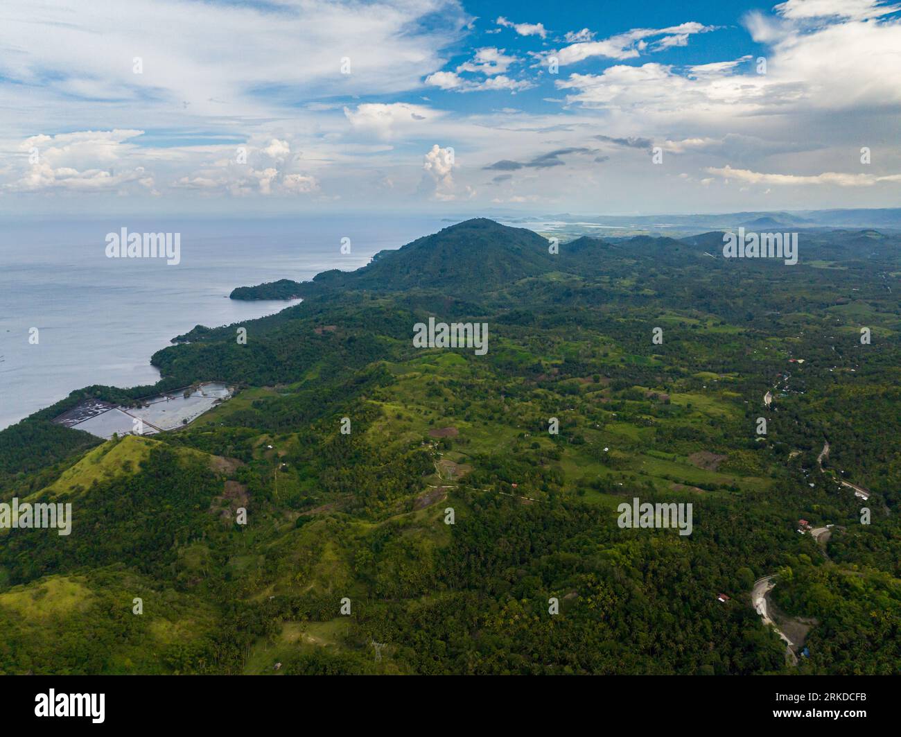 Tropical mountain with green forest and agricultural land in ...