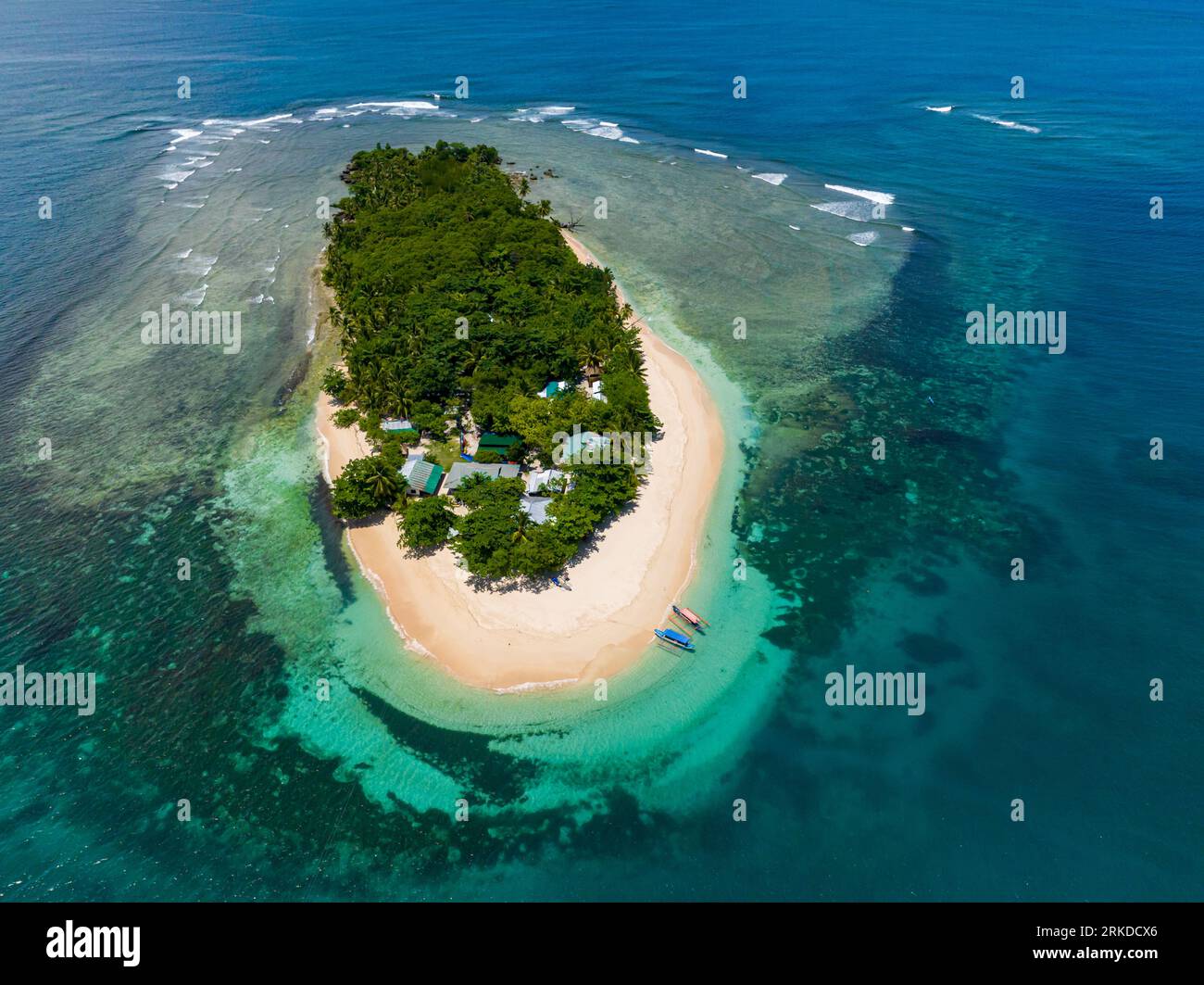 Tropical island surrounded by white sandy beach. Turquoise water and ...