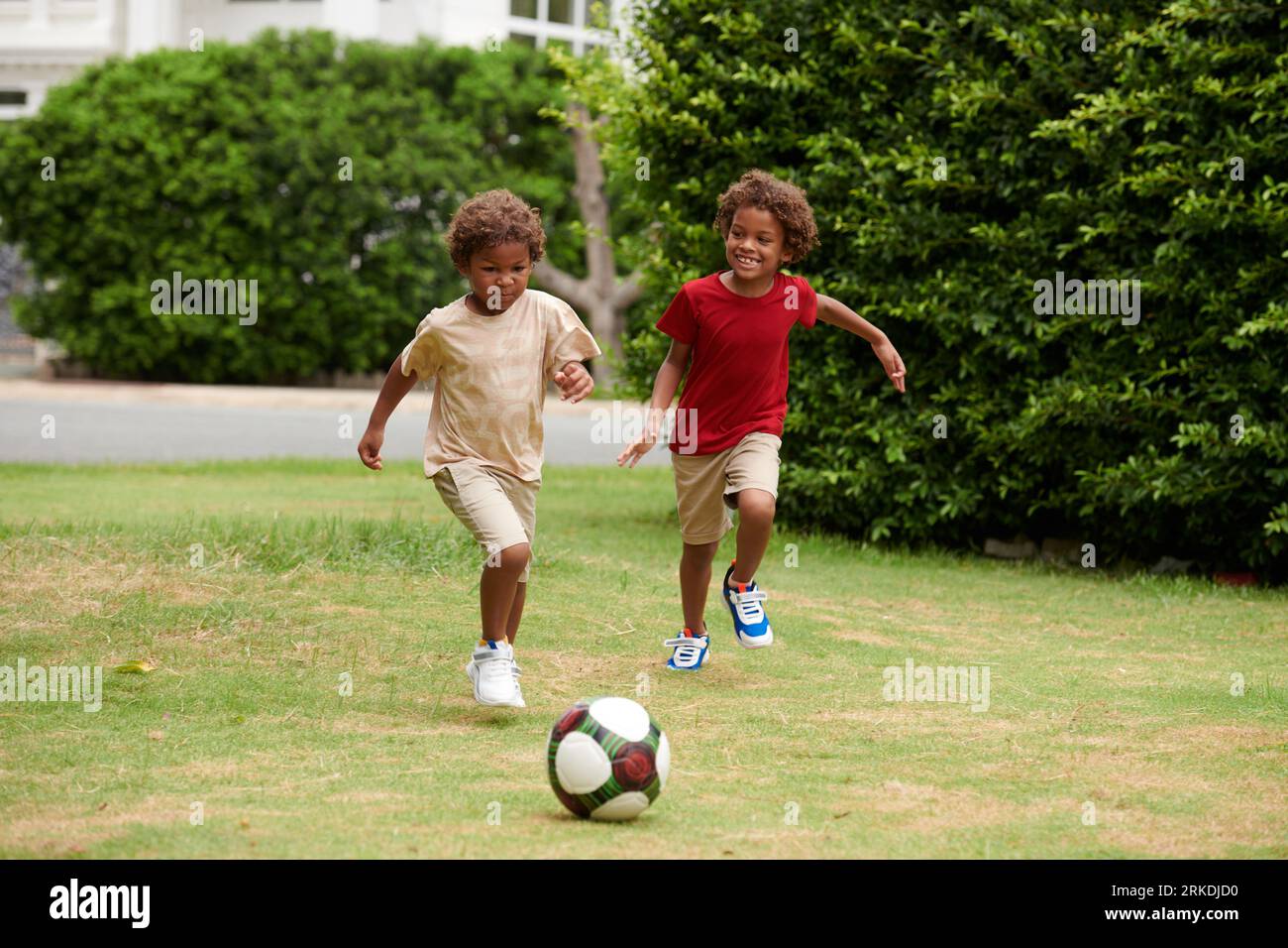 Boy running after soccer ball hi-res stock photography and images - Alamy