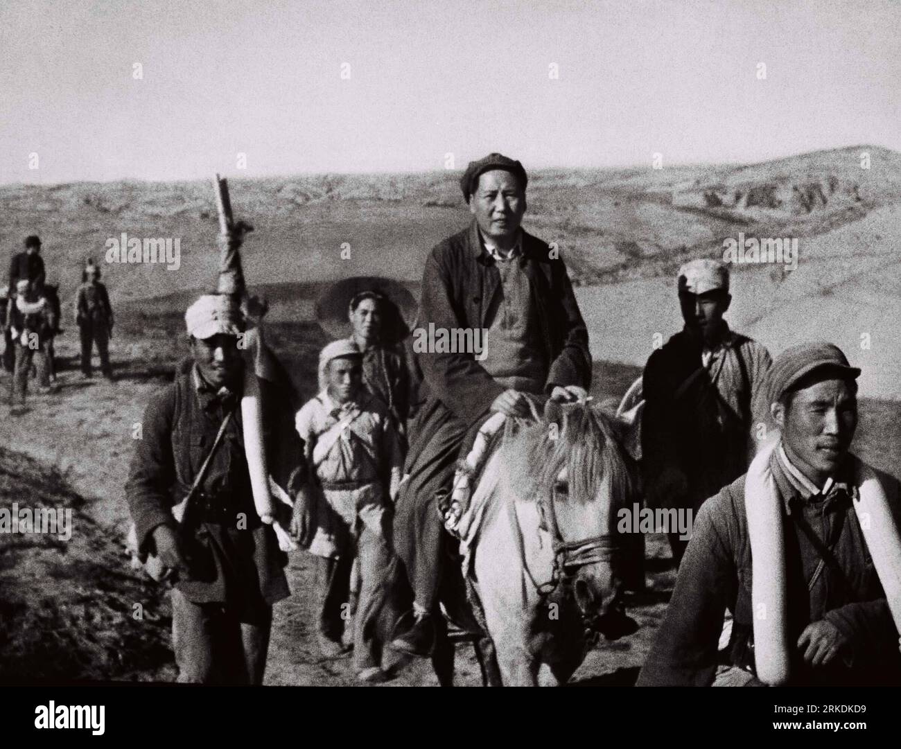 Mao Zedong (C) rides a horse on his way to the north part of Shaanxi ...