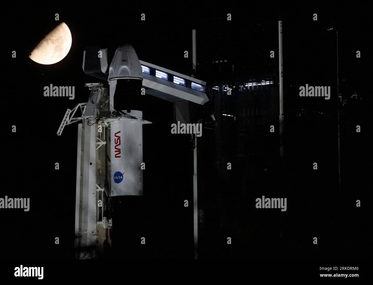 The Moon and the star Antares are seen in the sky above a SpaceX Falcon ...