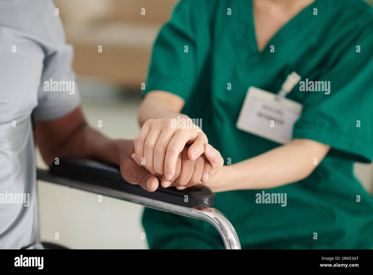 Caregiver touching hand of patient to express support Stock Photo - Alamy