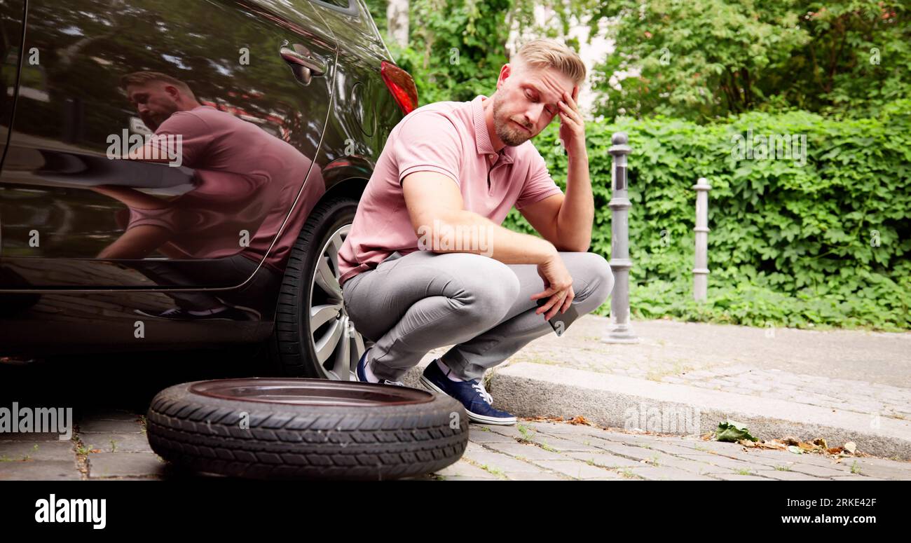 Car With Flat Tire. Man Calling On Phone Stock Photo - Alamy
