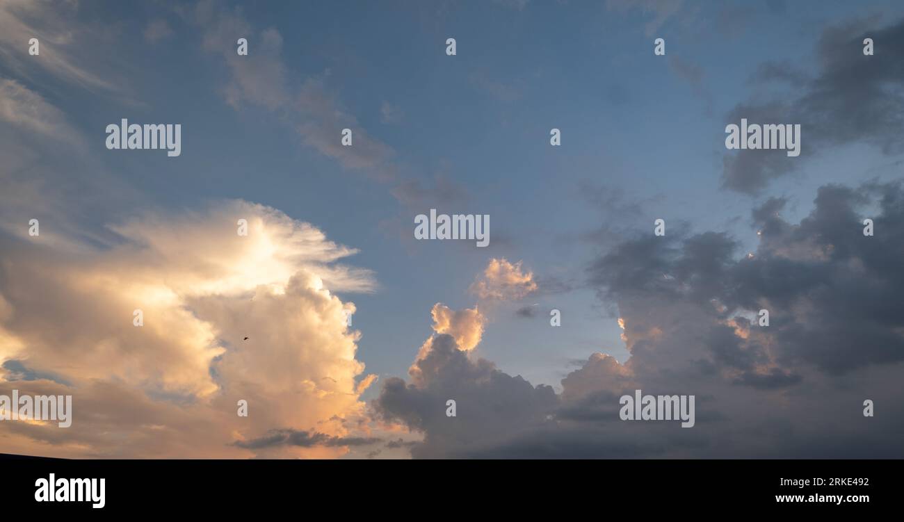 A captivating photo captures the serene evening sky as the descending ...