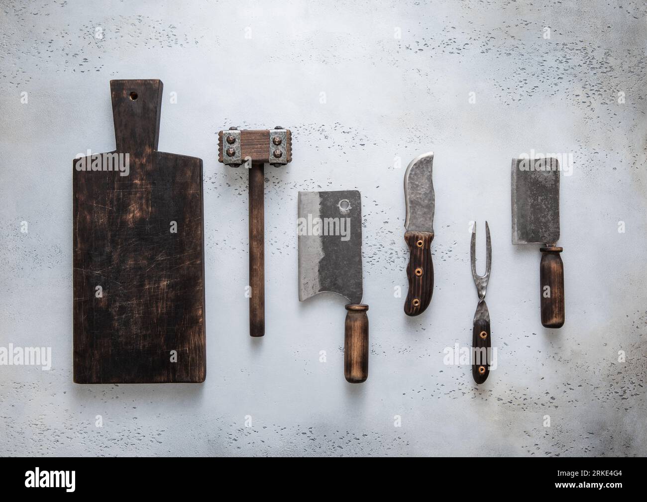 Kitchen meat utensils with wooden chopping board on light background ...