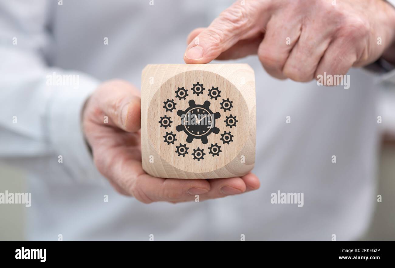 Hand holding a wooden cube with symbol of time management concept Stock ...